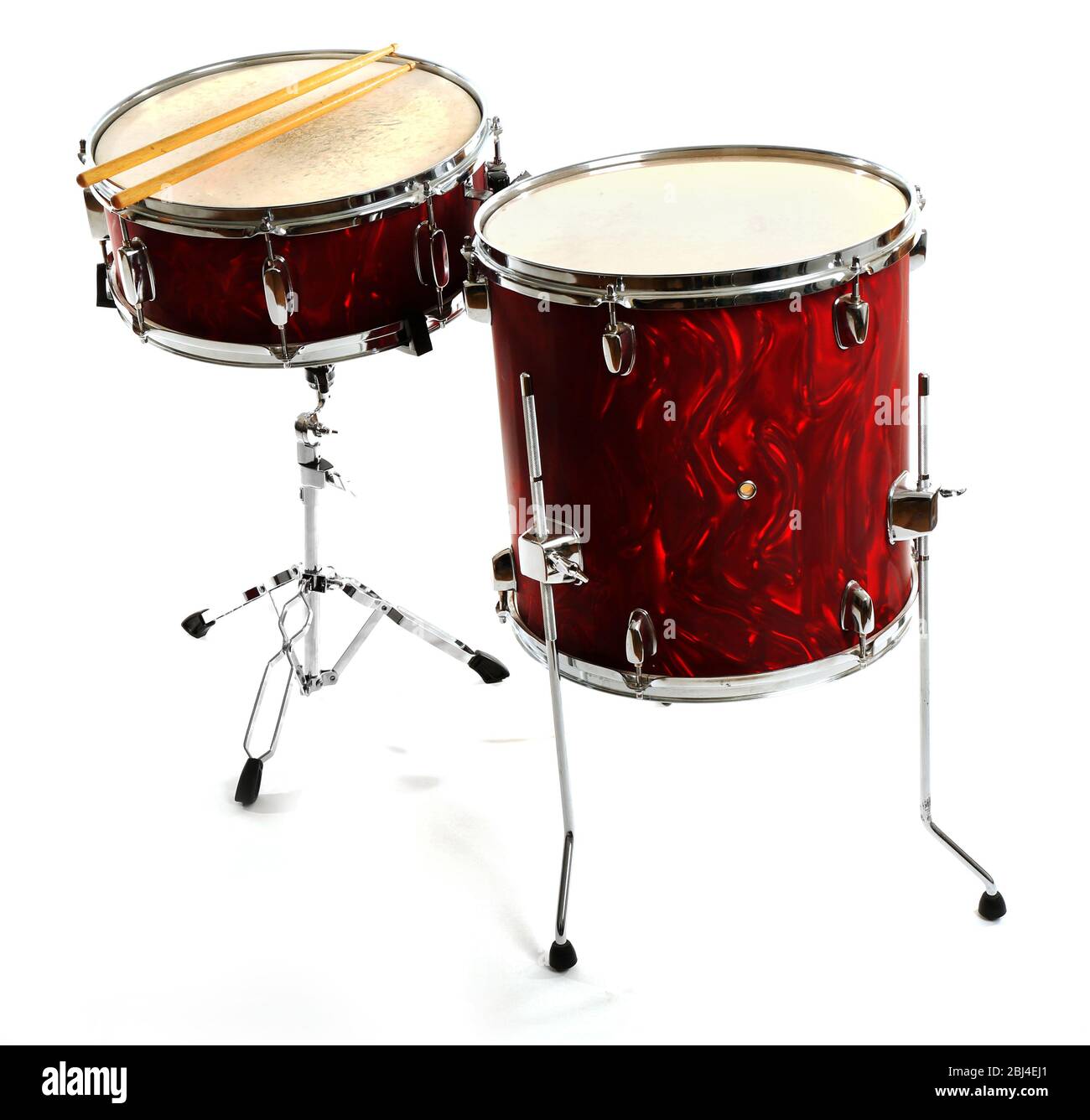 Red drums with drum sticks isolated on white background Stock Photo - Alamy