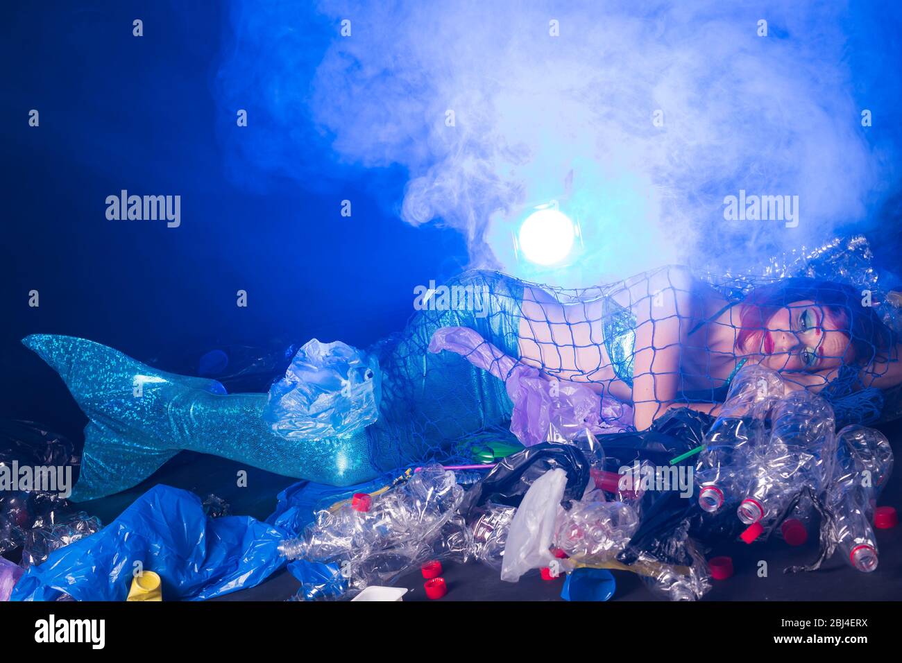 Sad fairytale mermaid in polluted ocean. Plastic trash and garbage in ...