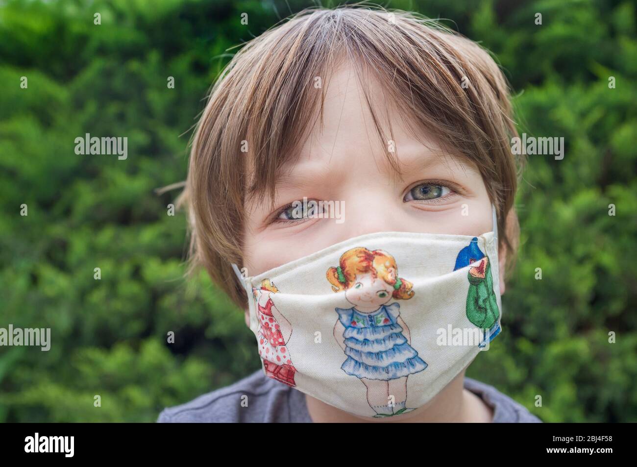 4 years little boy wearing a face mask print with children motifs ...