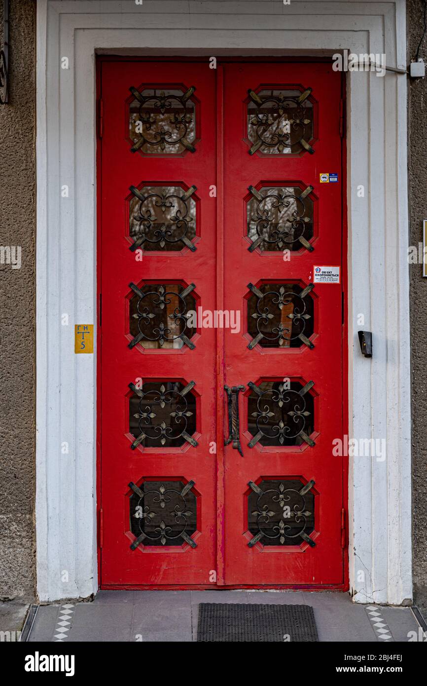 Retro style wooden doorway. Ornate red double door with rows of square ...