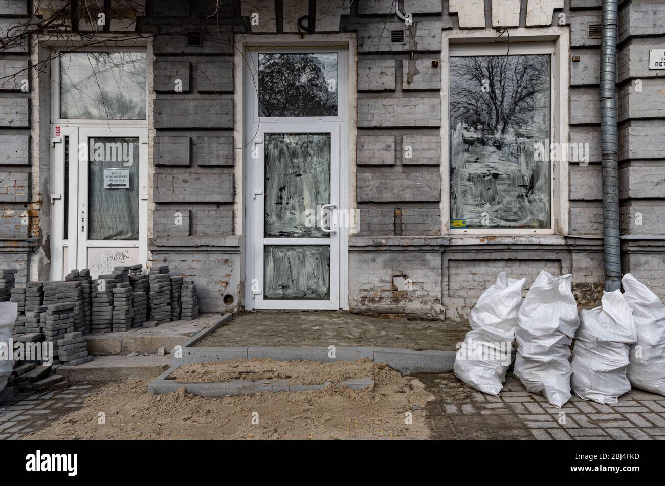 Reconstruction of old stone building with new white windows and blurry ...