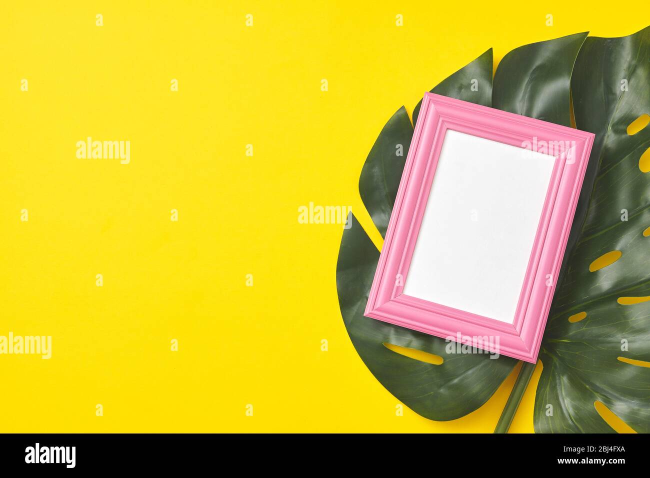 Empty pink frame isolated on yellow colourful background. Summer travel ...