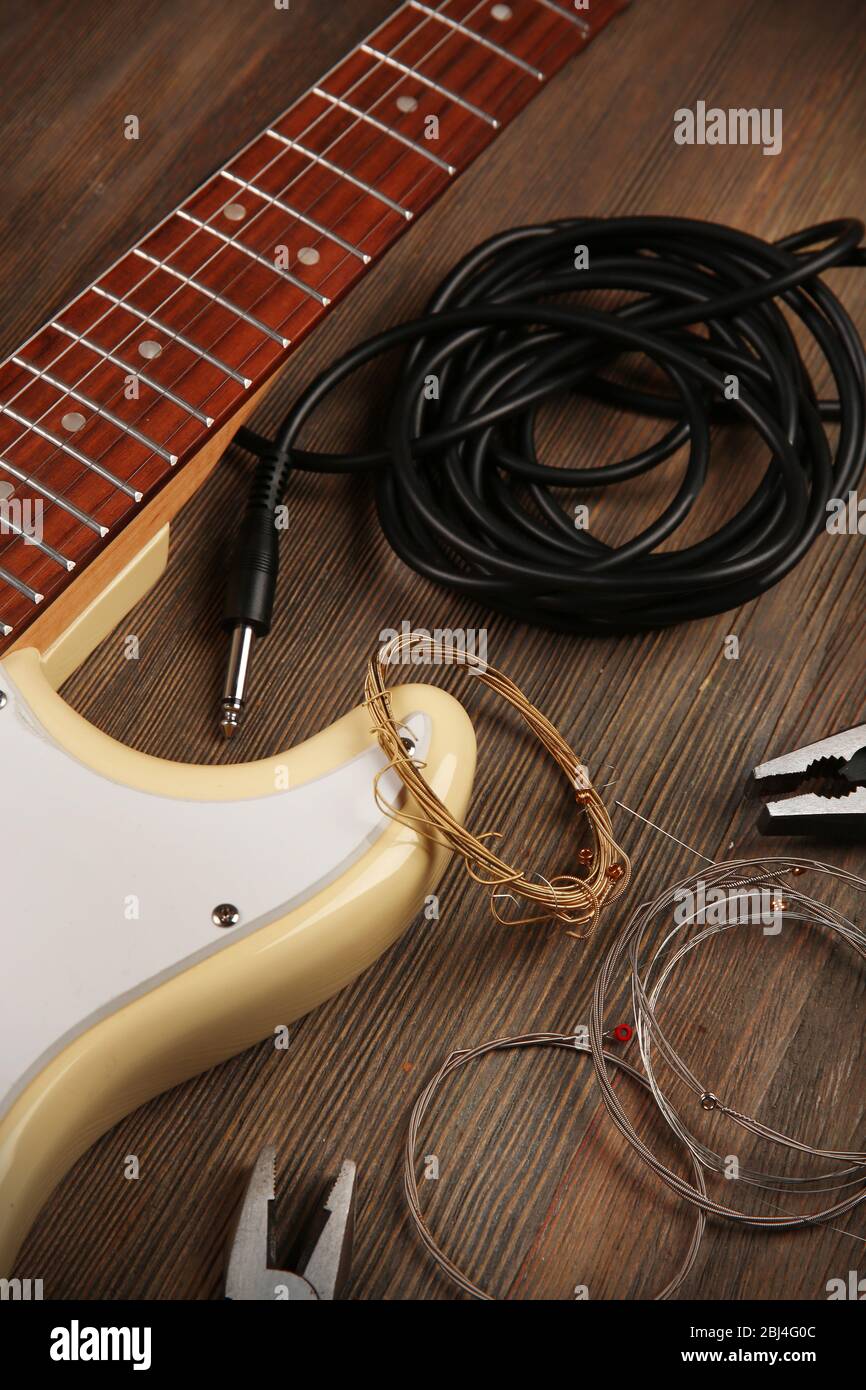 Electric guitar with musical equipment on wooden background Stock Photo ...