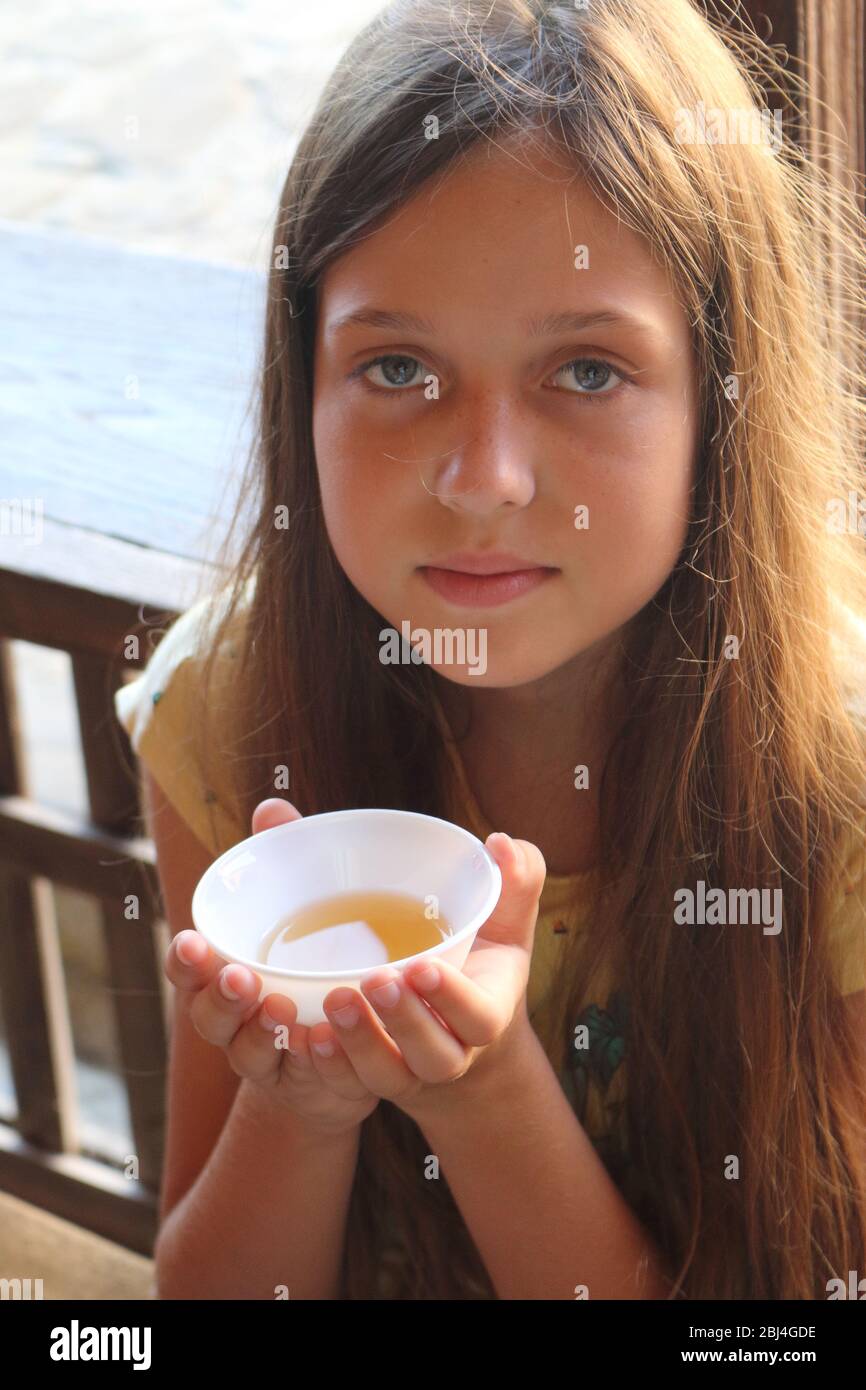 Girl tasting tea Stock Photo - Alamy