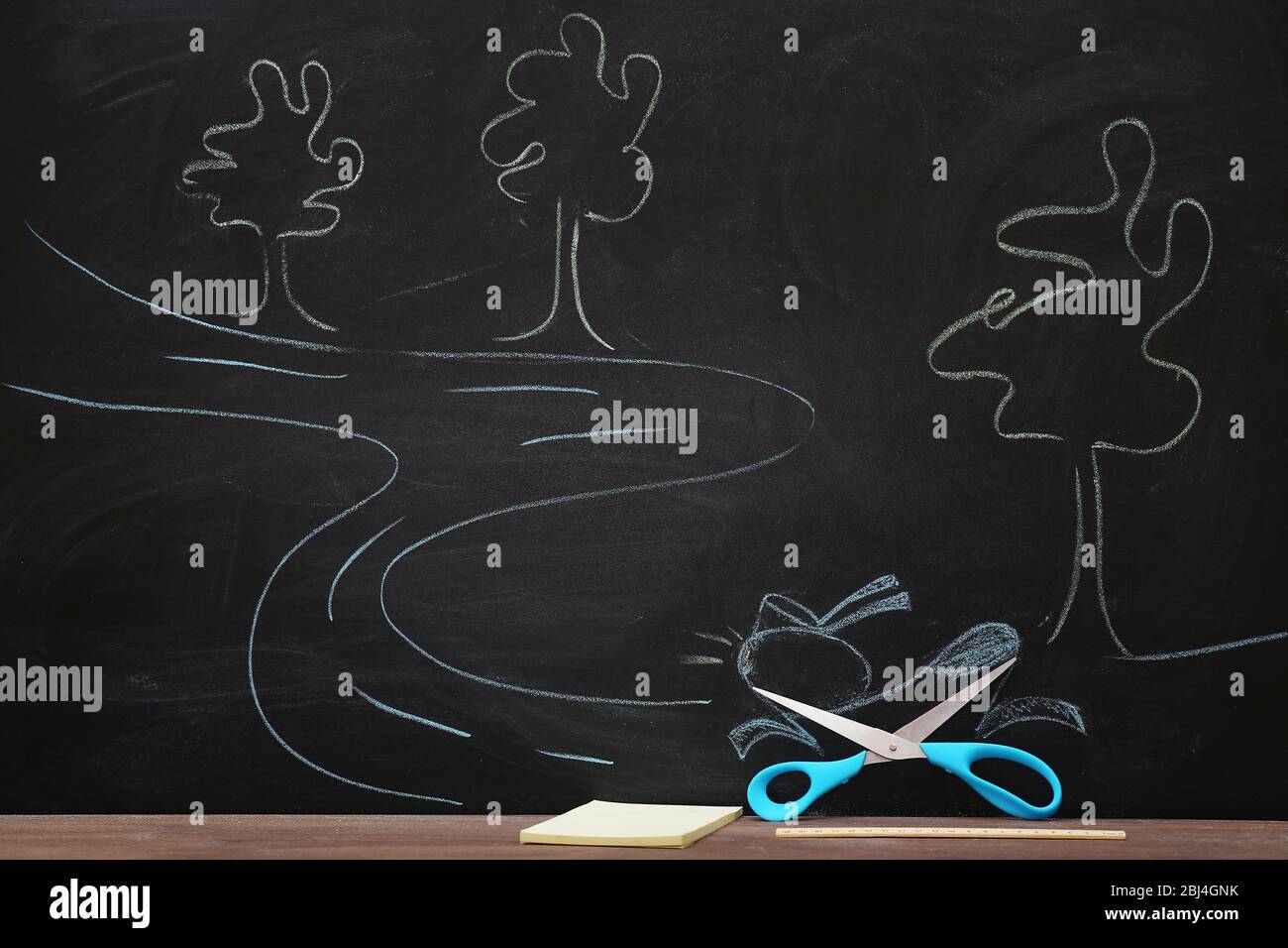 Funny composition of office supplies and pictures drawn with chalk on ...