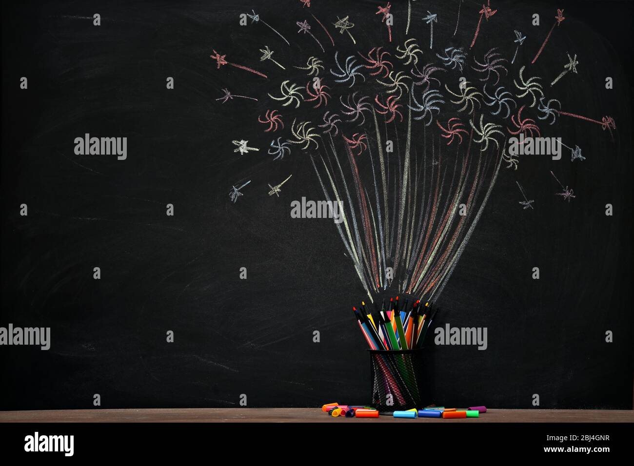 Funny composition of office supplies and pictures drawn with chalk on ...