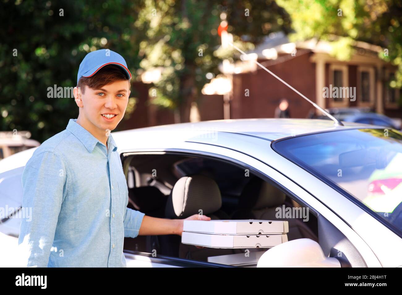 Free delivery man riding hi-res stock photography and images - Alamy