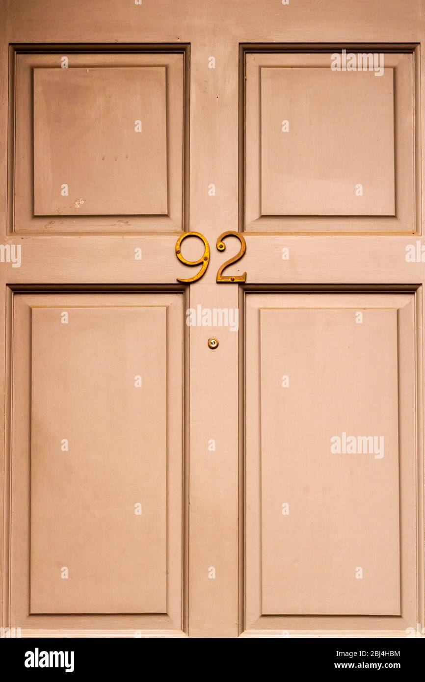 House number 92 in thin elegant metal digits on a traditional panelled ...