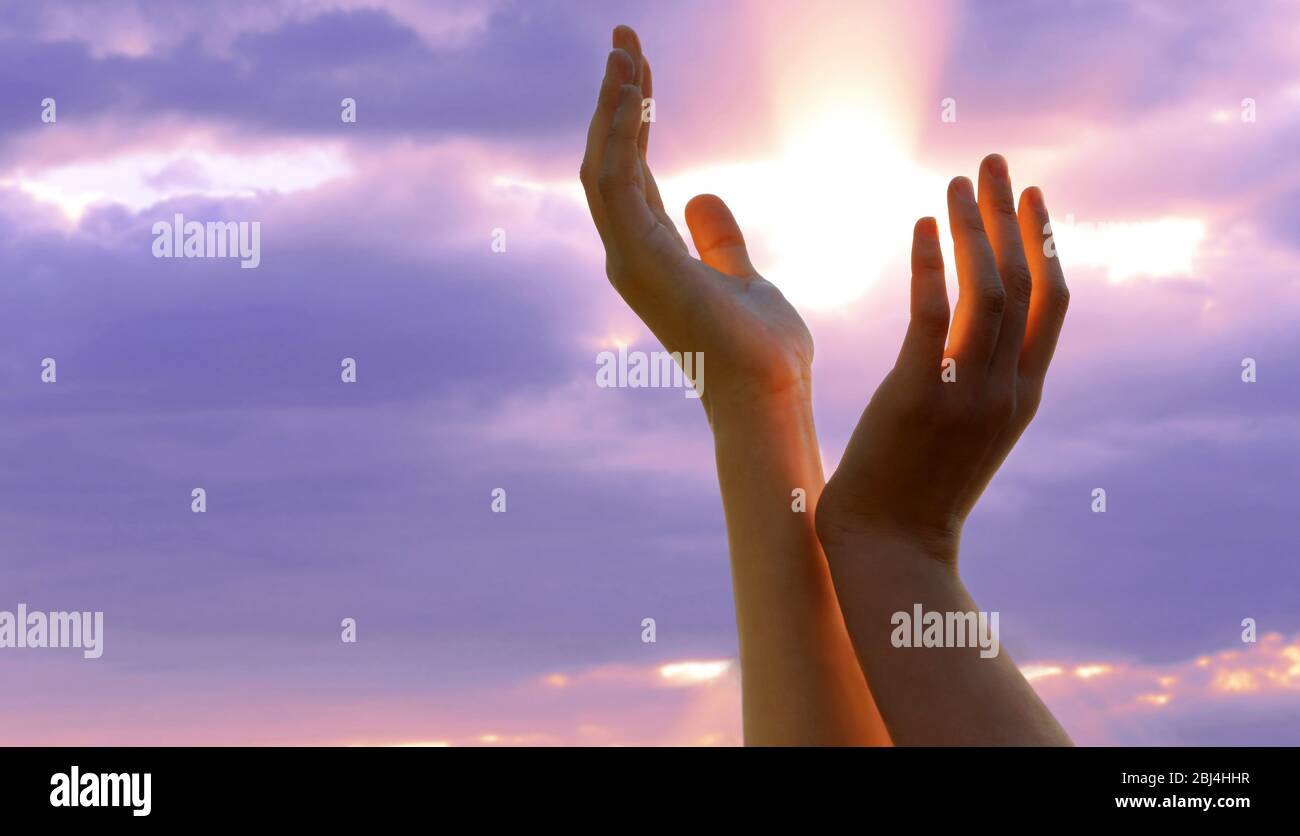 Hands on sunlight background Stock Photo - Alamy