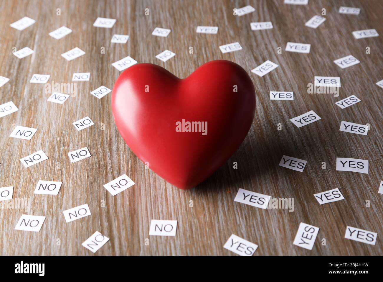 Red heart with yes and no on wooden background Stock Photo - Alamy