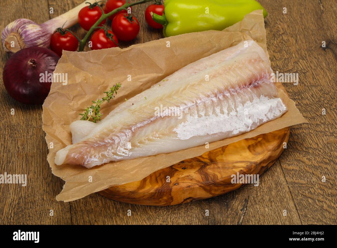 Pollack fillet raw ready for cooking over wooden Stock Photo - Alamy