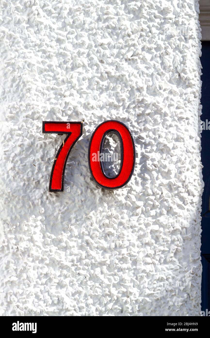 House number 70 in radiant red Stock Photo - Alamy