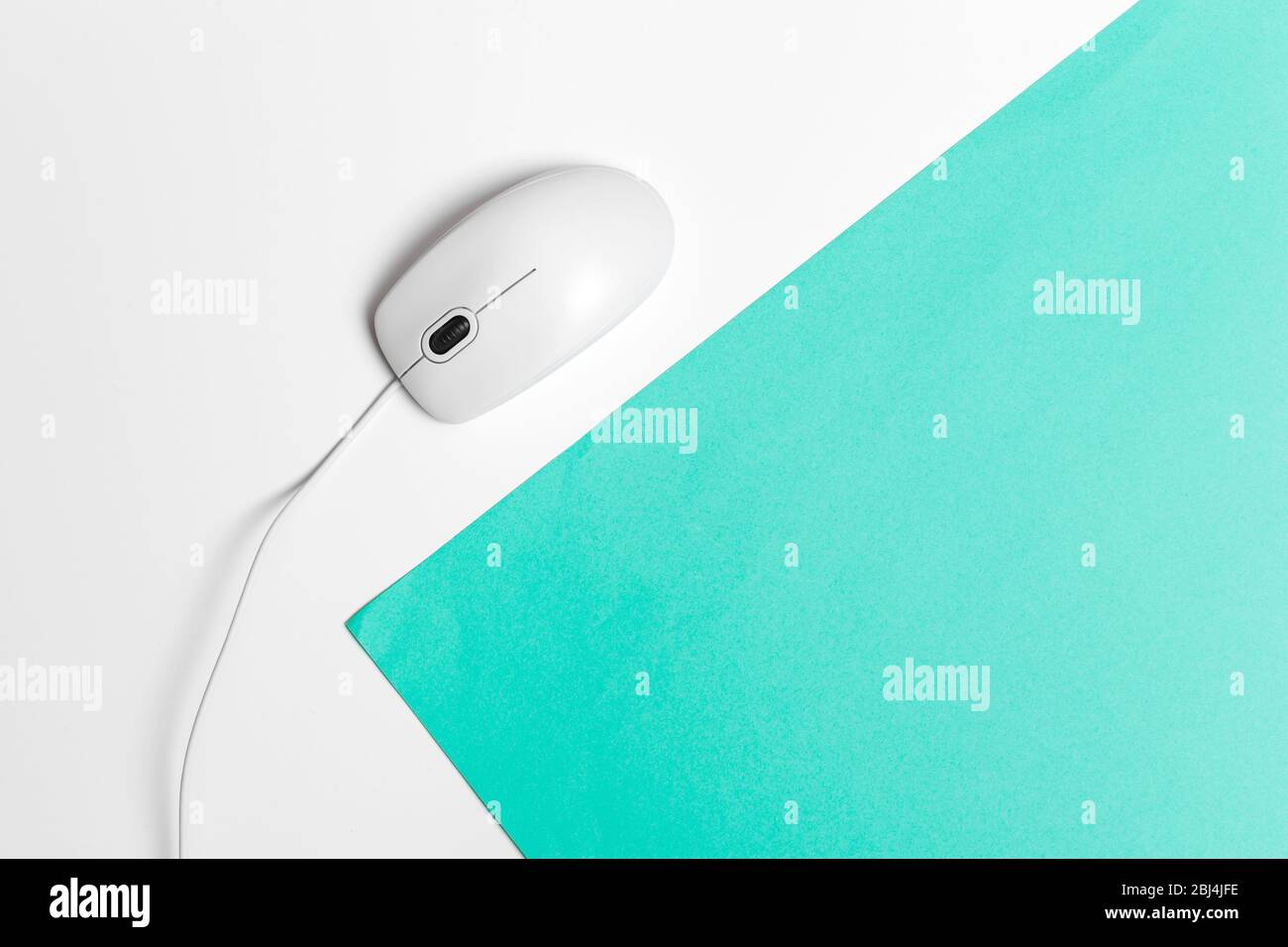 Computer mouse on a turquoise paper background Stock Photo - Alamy
