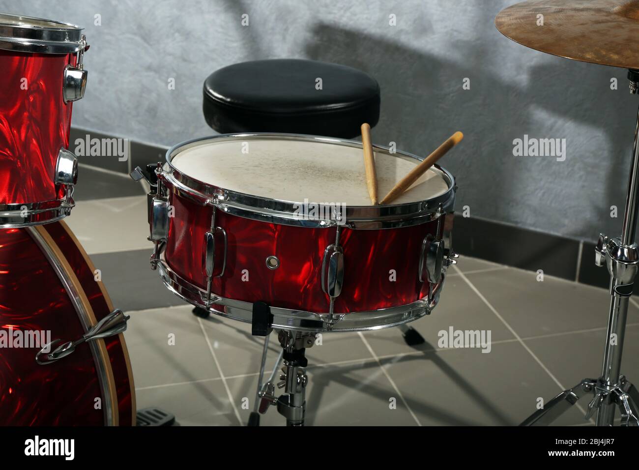 Drum set on brick wall background Stock Photo - Alamy