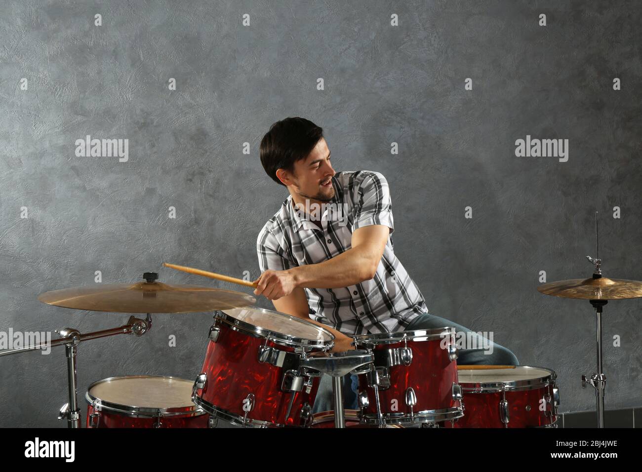 Musician playing the drums in a studio Stock Photo - Alamy