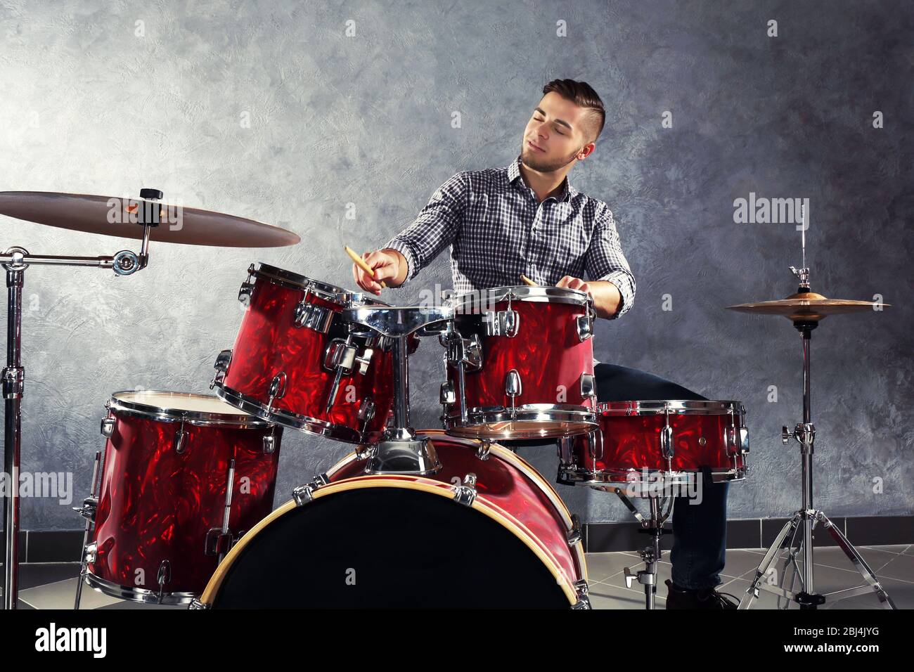 Musician playing the drums in a studio Stock Photo - Alamy