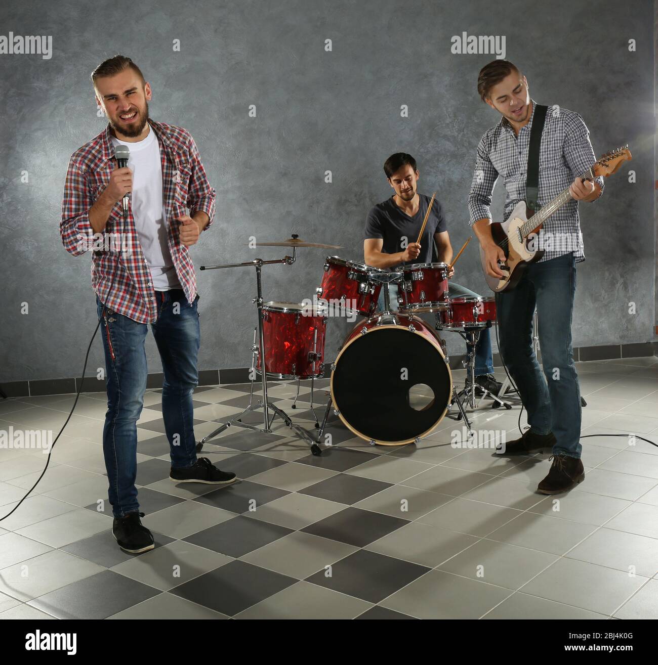 Musicians playing musical instruments and singing songs in a studio ...