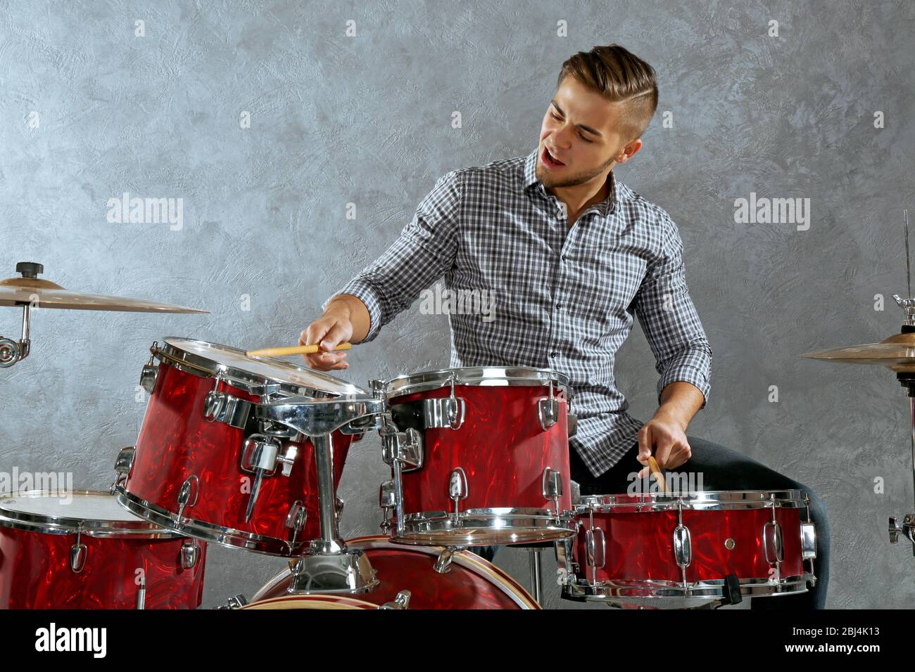 Musician playing the drums in a studio Stock Photo - Alamy
