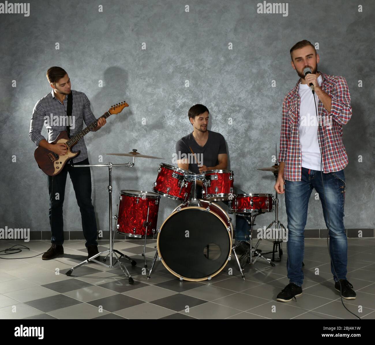 Musicians playing musical instruments and singing songs in a studio ...