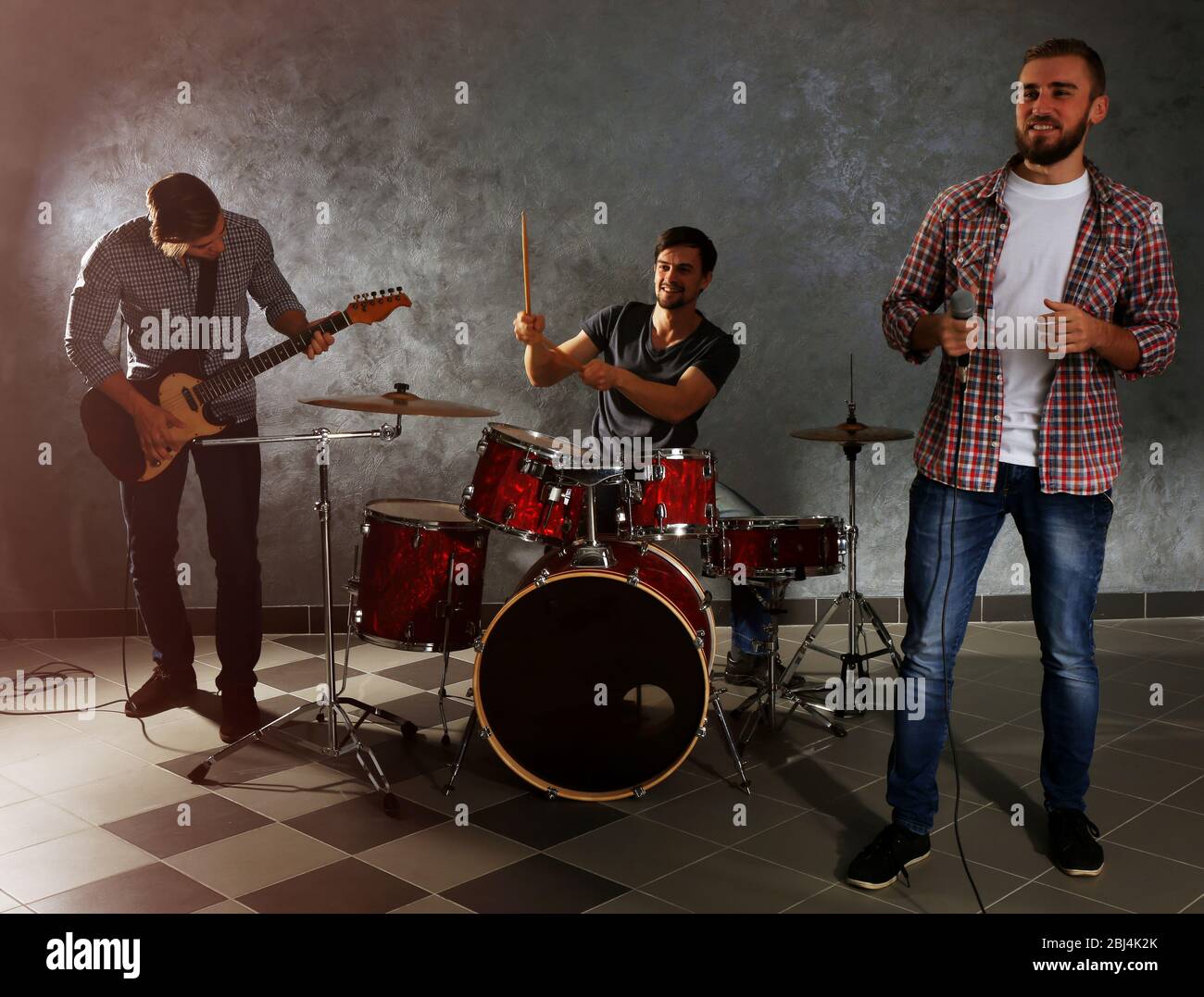 Musicians playing musical instruments and singing songs in a studio ...