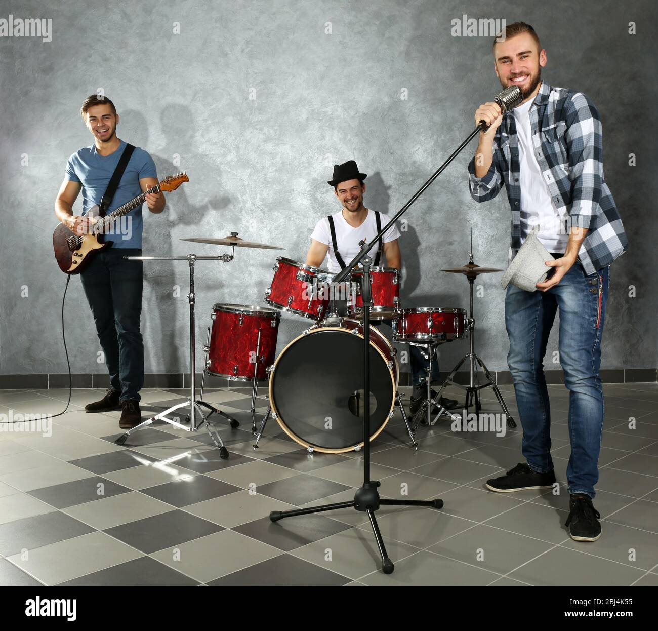 Musicians playing musical instruments and singing songs in a studio ...