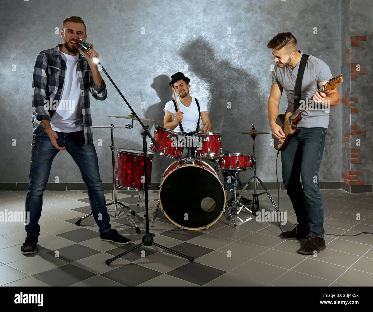 Musicians playing musical instruments and singing songs in a studio ...