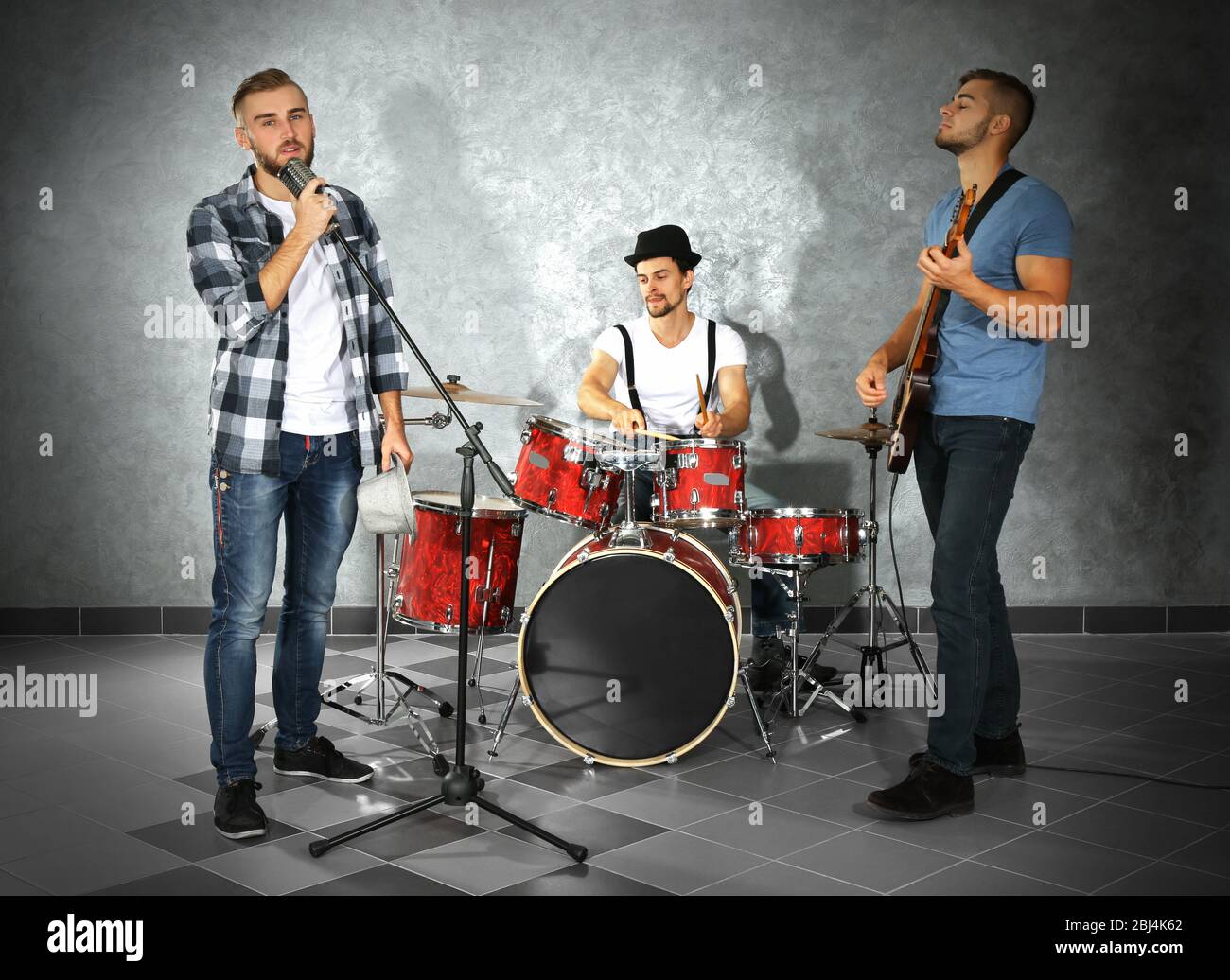 Musicians playing musical instruments and singing songs in a studio ...