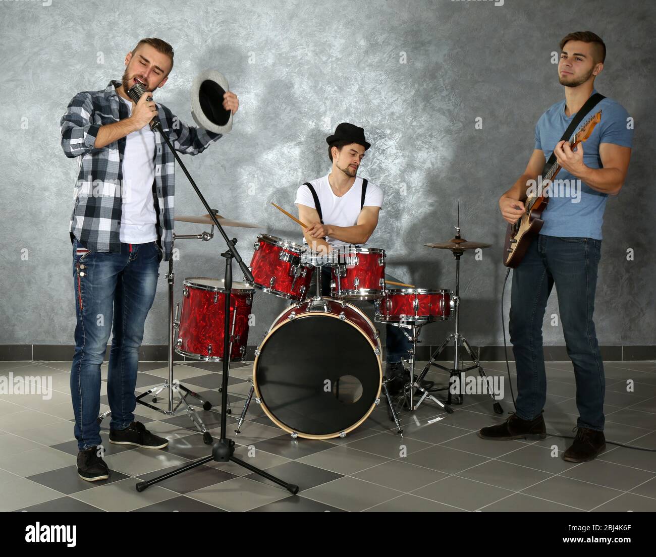 Musicians playing musical instruments and singing songs in a studio ...