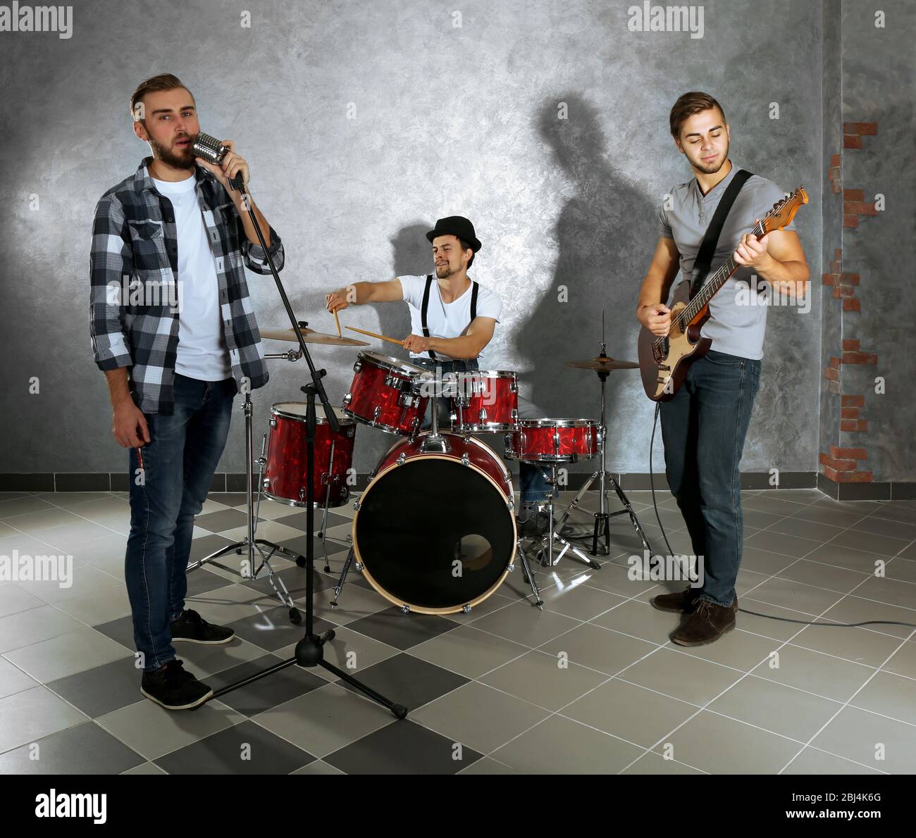 Musicians playing musical instruments and singing songs in a studio ...