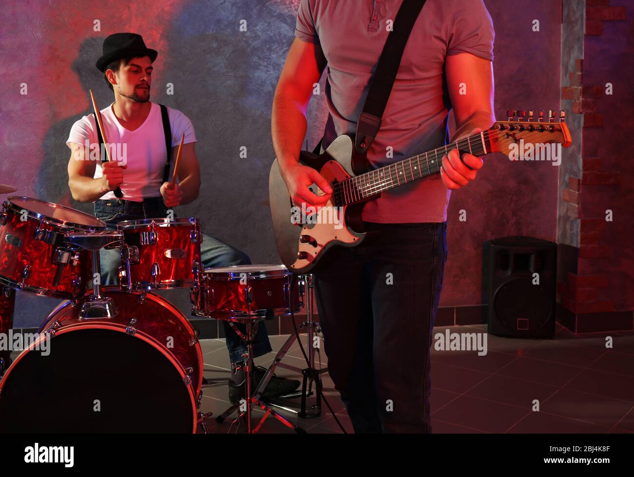 Musicians playing musical instruments and singing songs in a studio ...