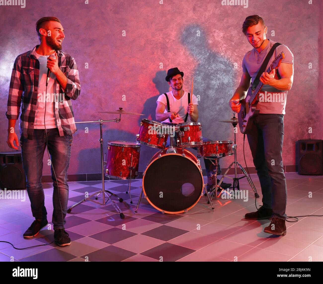 Musicians playing musical instruments and singing songs in a studio ...