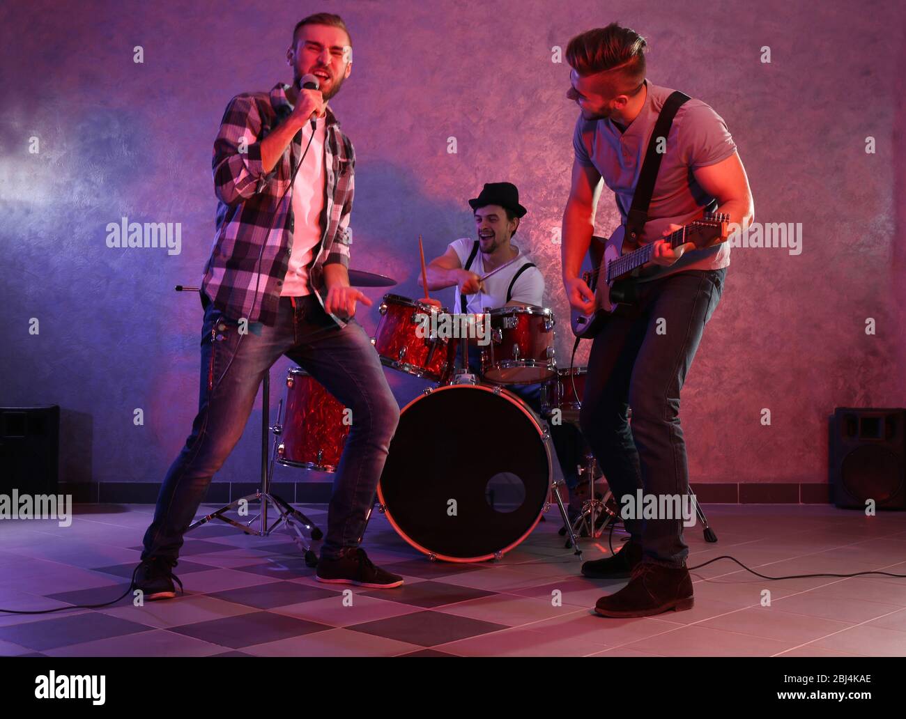 Musicians playing musical instruments and singing songs in a studio ...