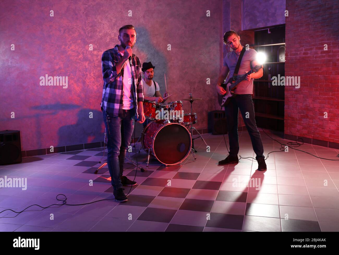 Musicians playing musical instruments and singing songs in a studio ...