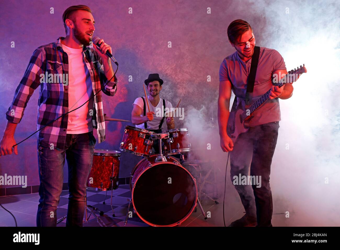 Musicians playing musical instruments and singing songs in a studio ...