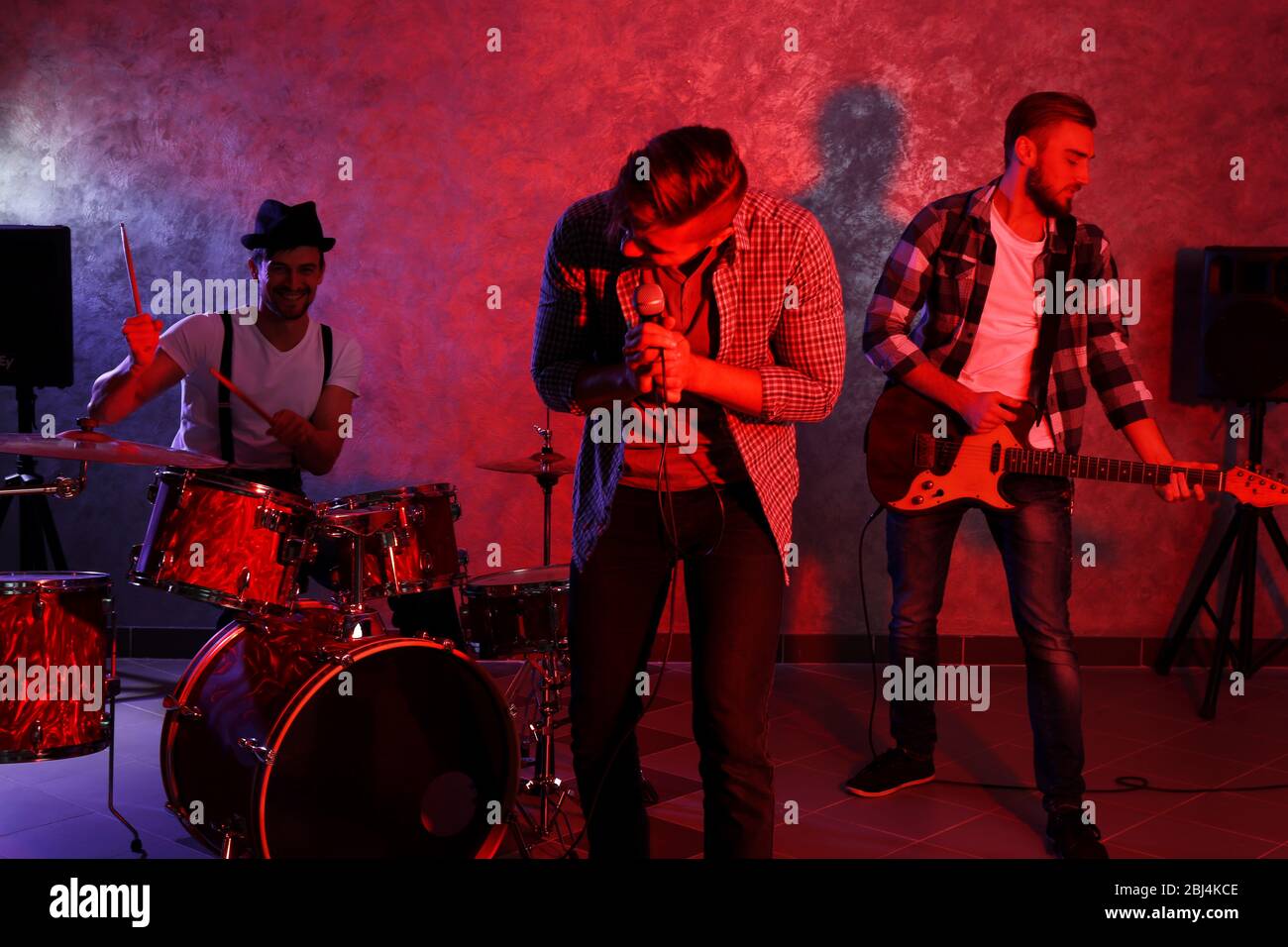 Musicians playing musical instruments and singing songs in a studio ...