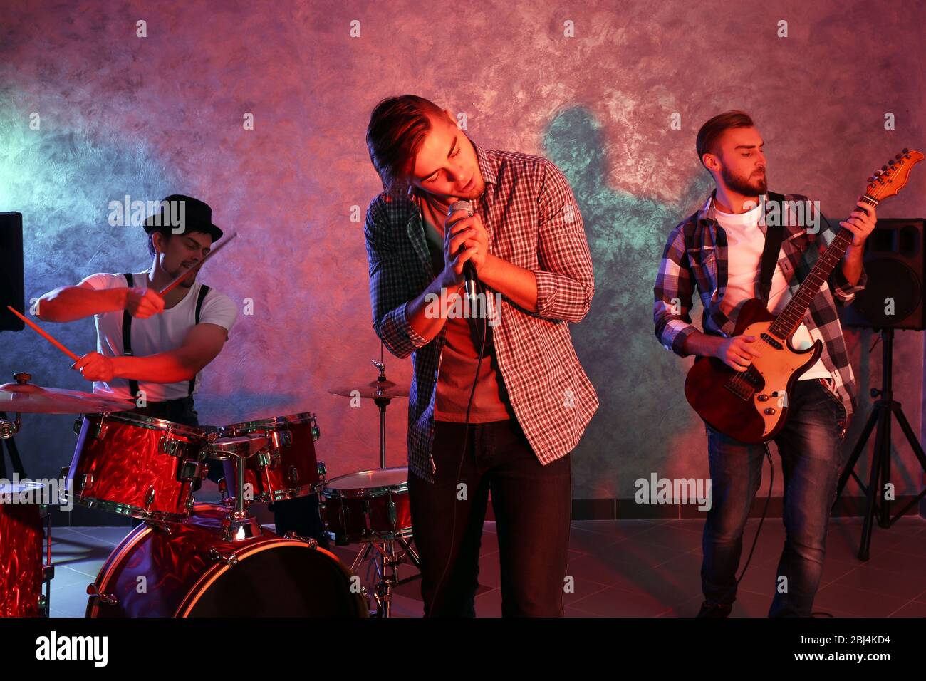 Musicians playing musical instruments and singing songs in a studio ...