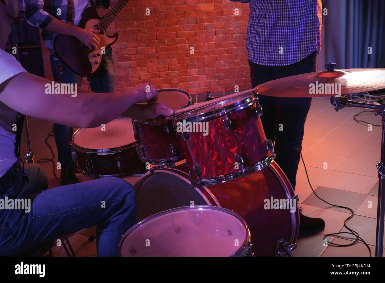 Musicians playing musical instruments on brick wall background Stock ...