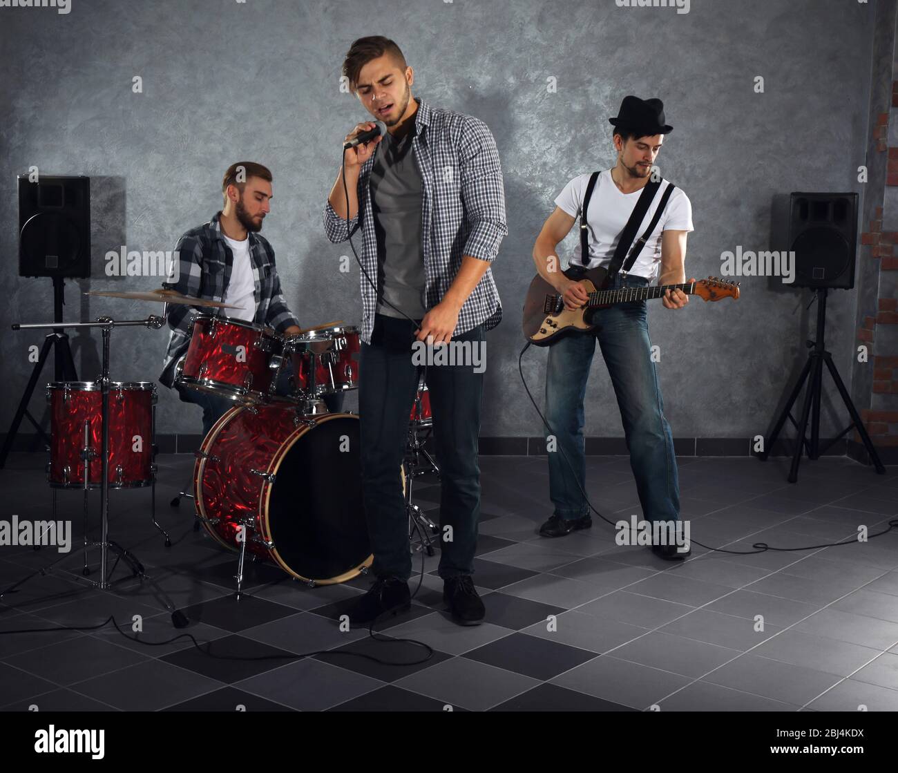 Musicians playing musical instruments and singing songs in a studio ...