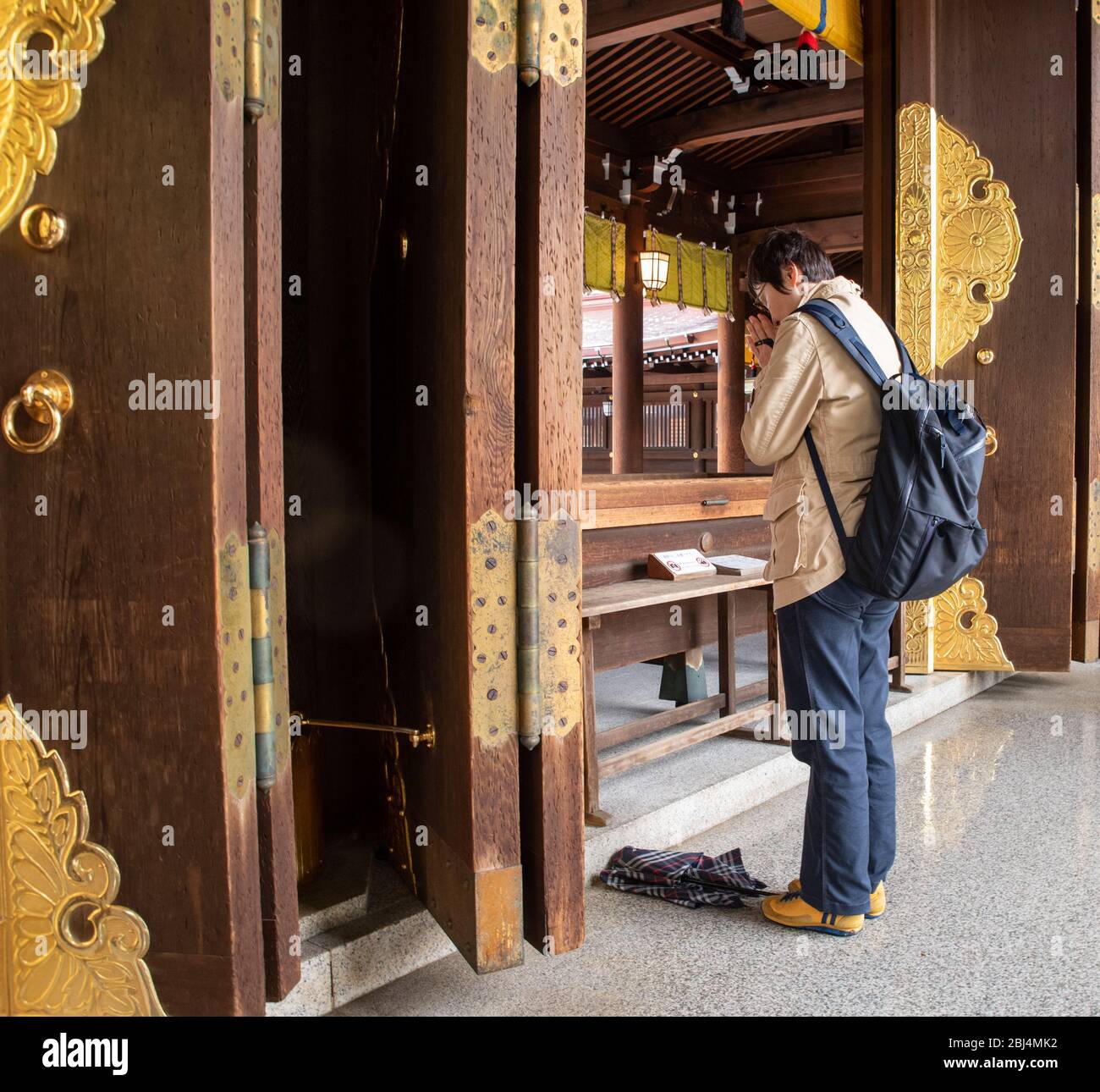 A person praying at the Meiji shrine it Tokyo, Japan Stock Photo - Alamy