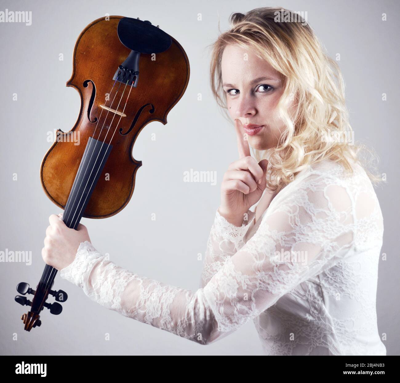 attention silence please violin player hold instrument Stock Photo - Alamy