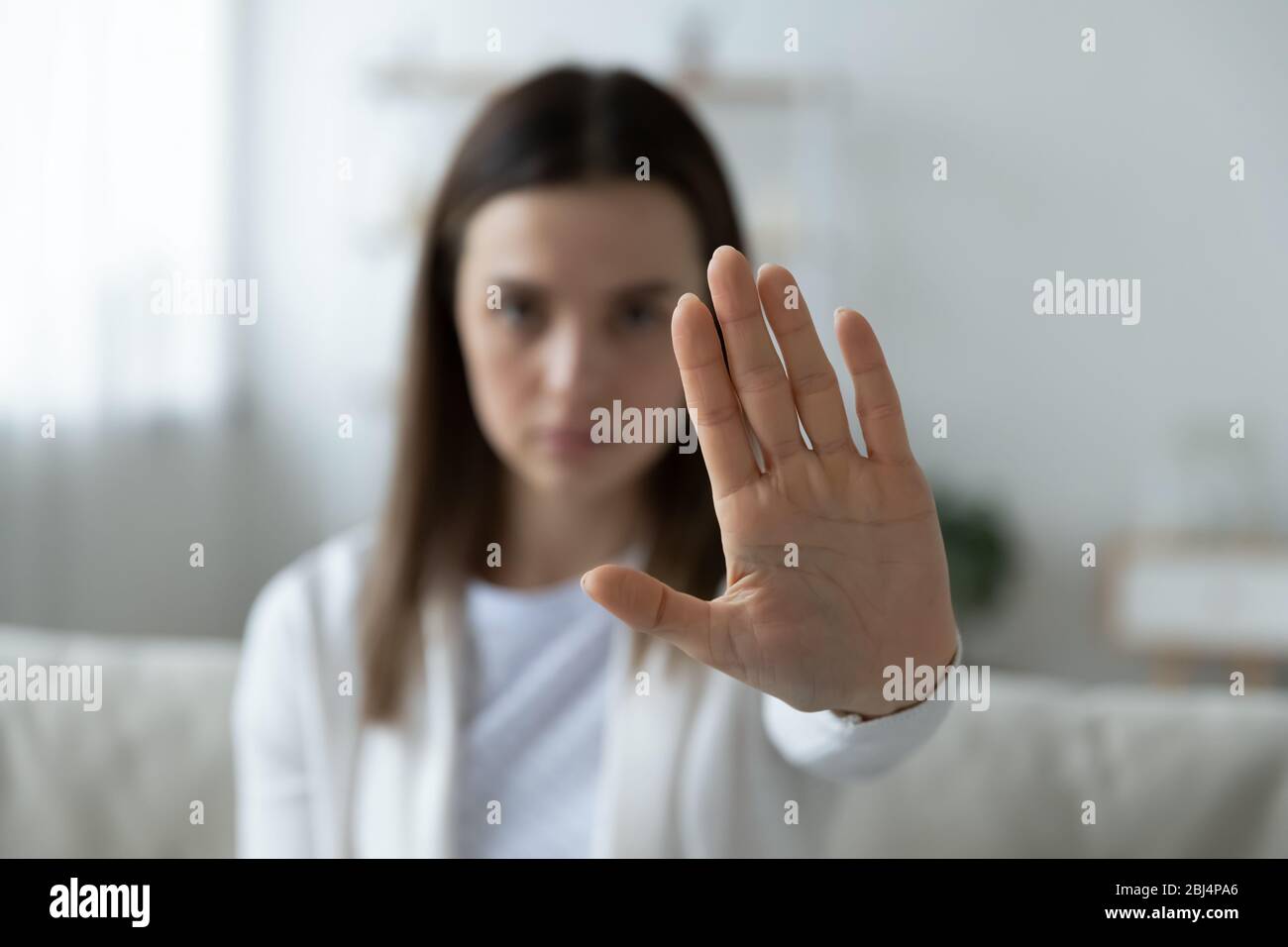 Young woman show stop gesture demonstrate protest Stock Photo - Alamy