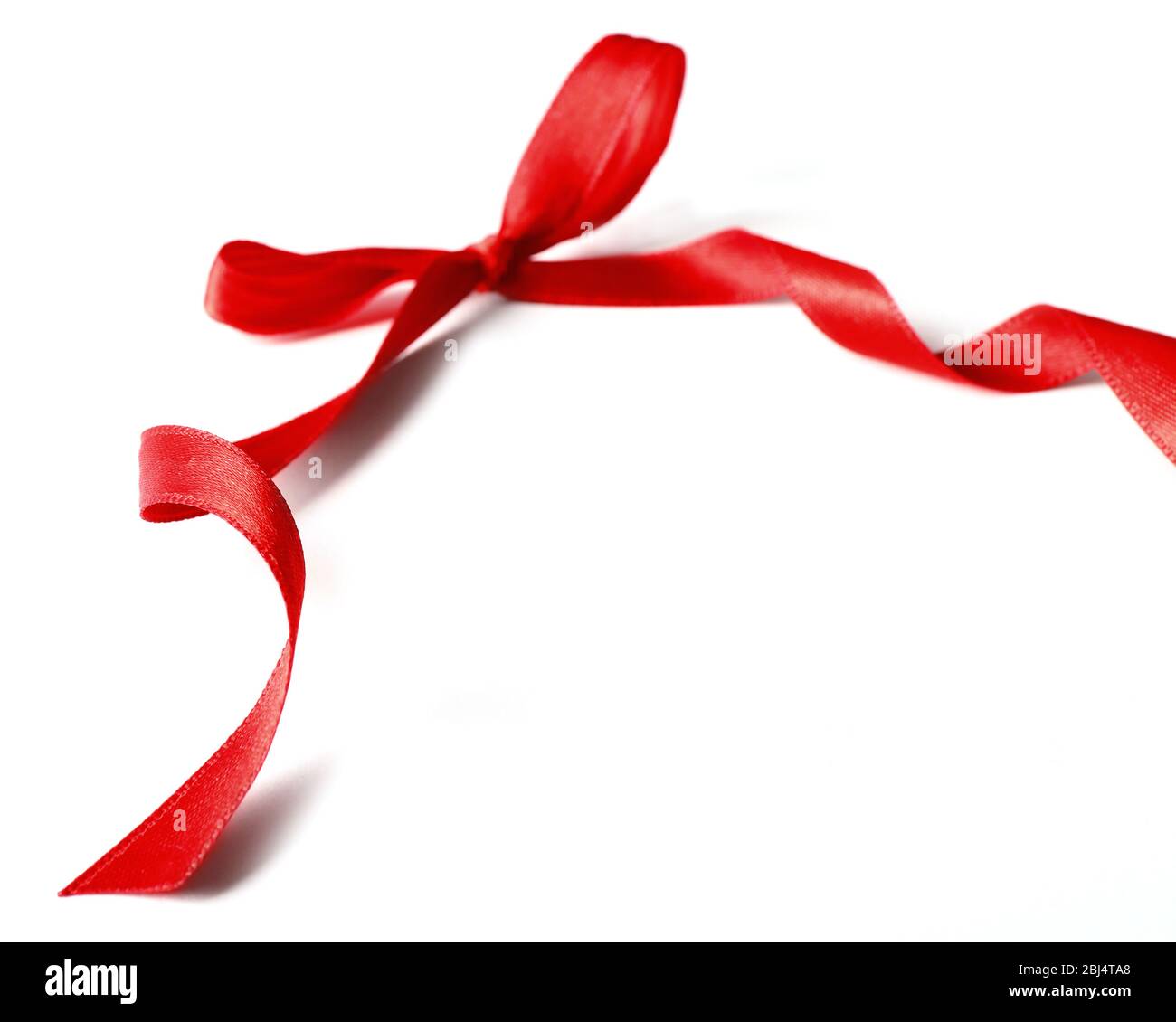 Shiny red bow isolated on white Stock Photo - Alamy