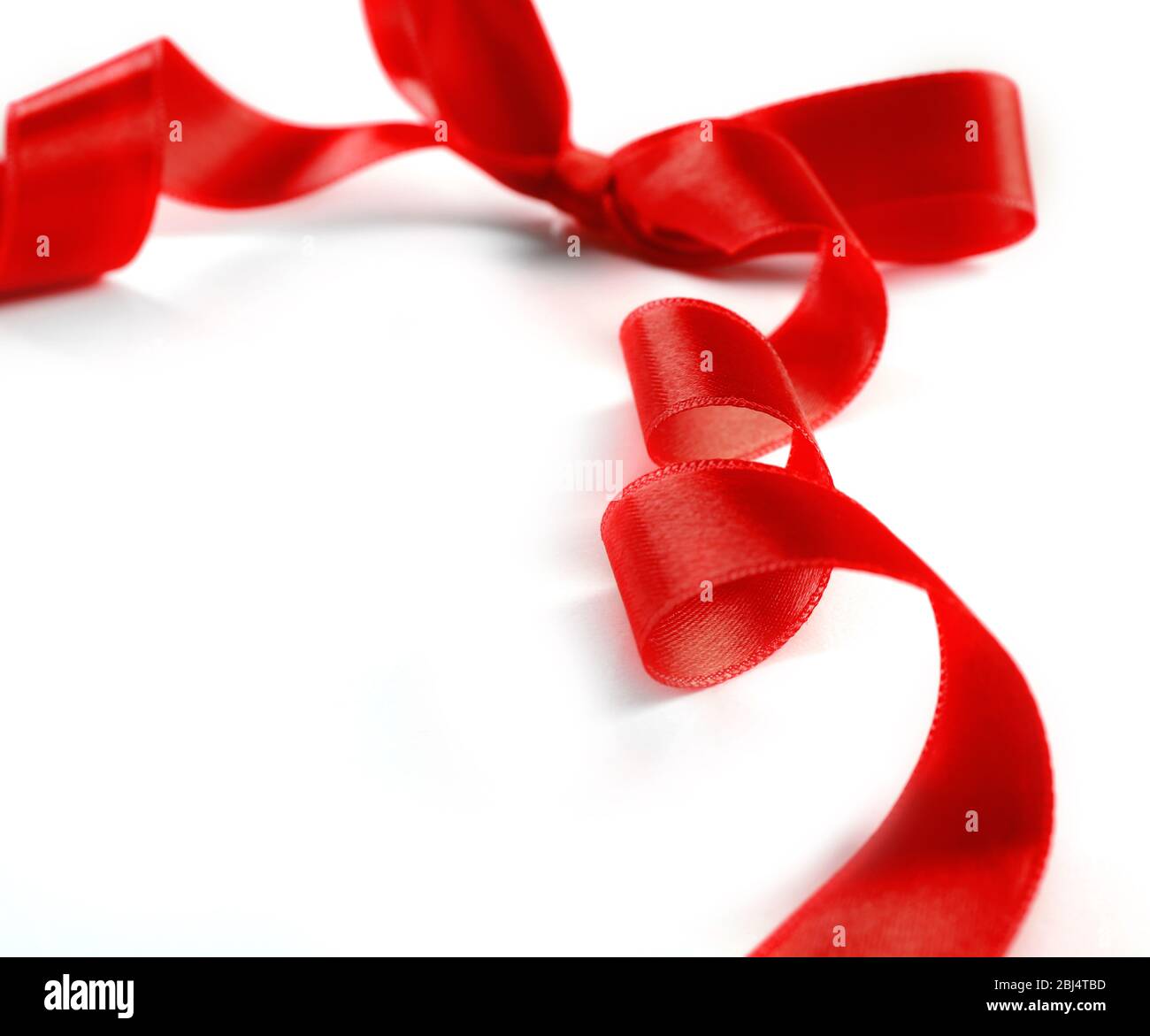 Shiny red bow isolated on white Stock Photo - Alamy