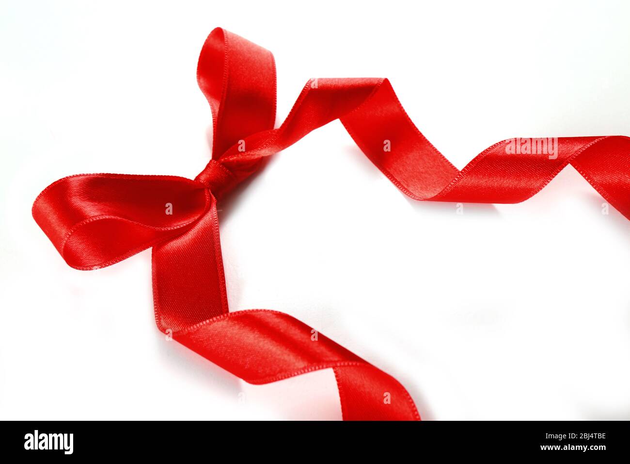 Shiny red bow isolated on white Stock Photo - Alamy