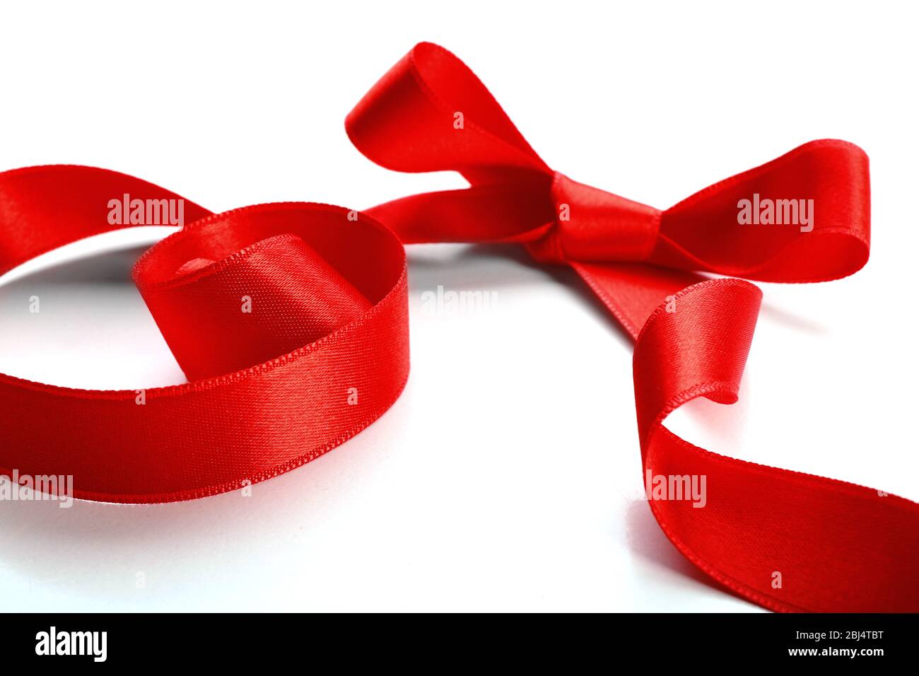 Shiny red bow isolated on white Stock Photo - Alamy