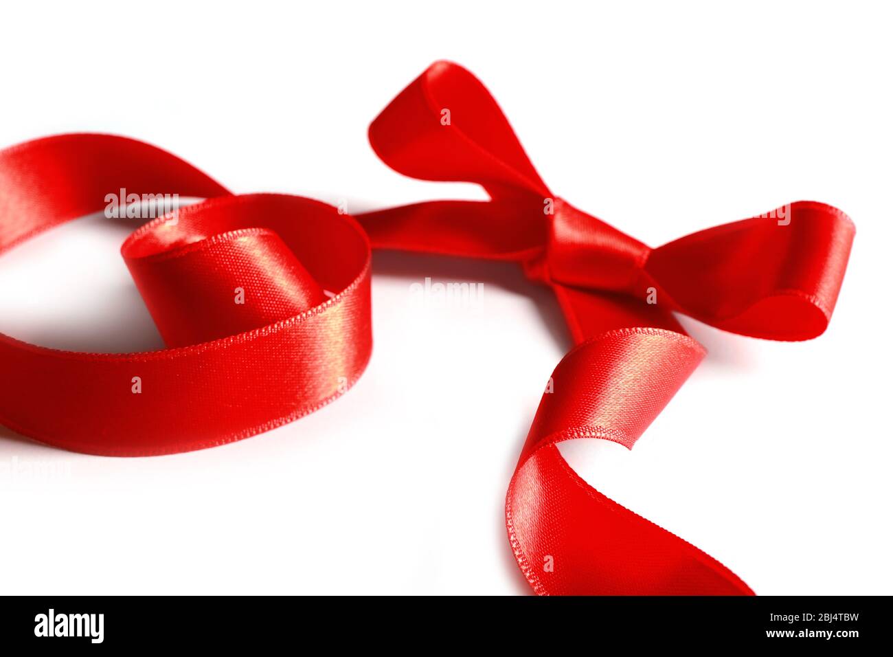 Shiny red bow isolated on white Stock Photo - Alamy