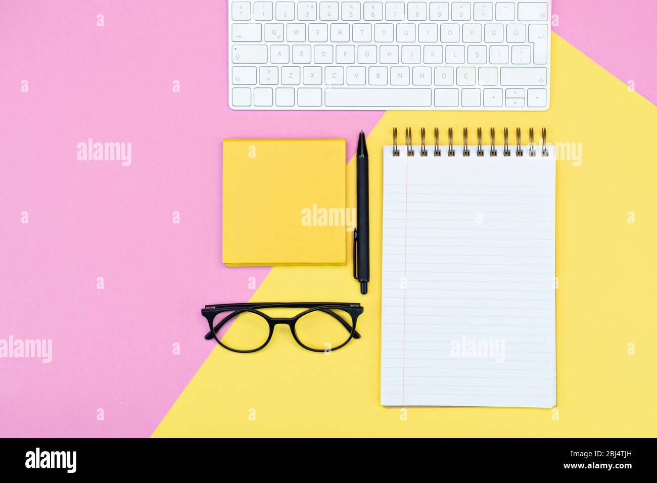 pink and yellow colorful desk table layout. note book paper. diary ...