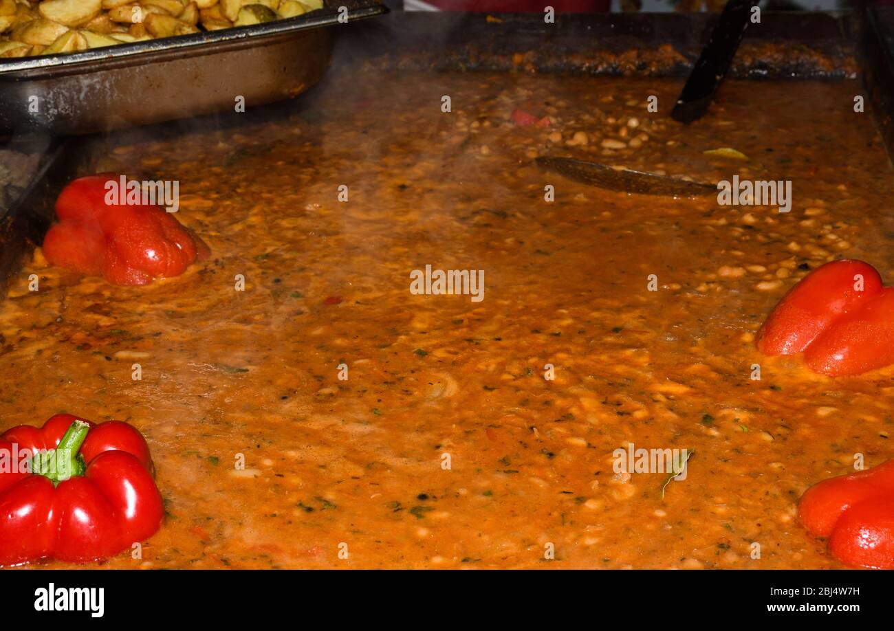 Beans stew, chili sin carne, large pot on fire cooking during food ...