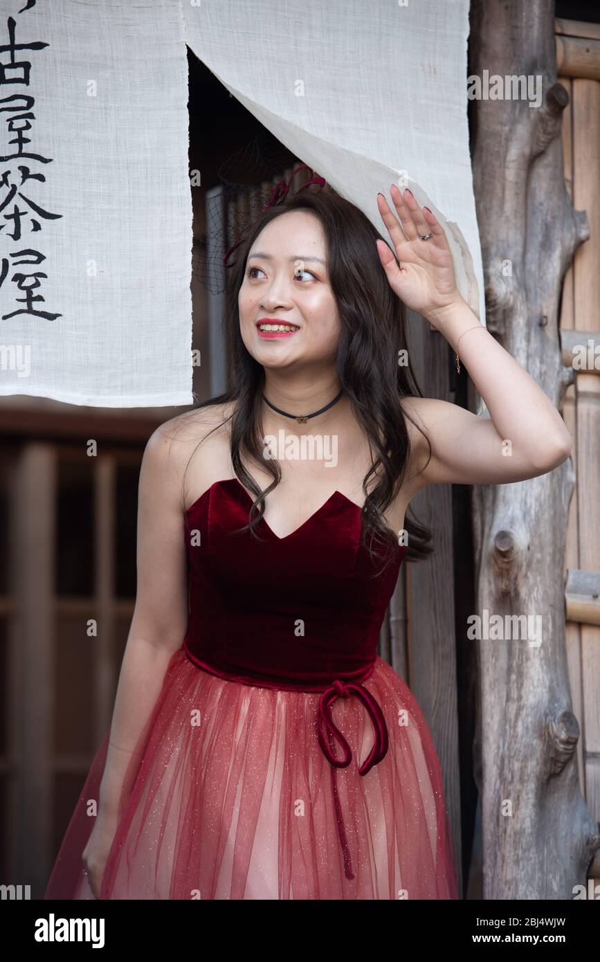 A tourist at Kyoto's Sannenzaka street waving hello to passers by and ...
