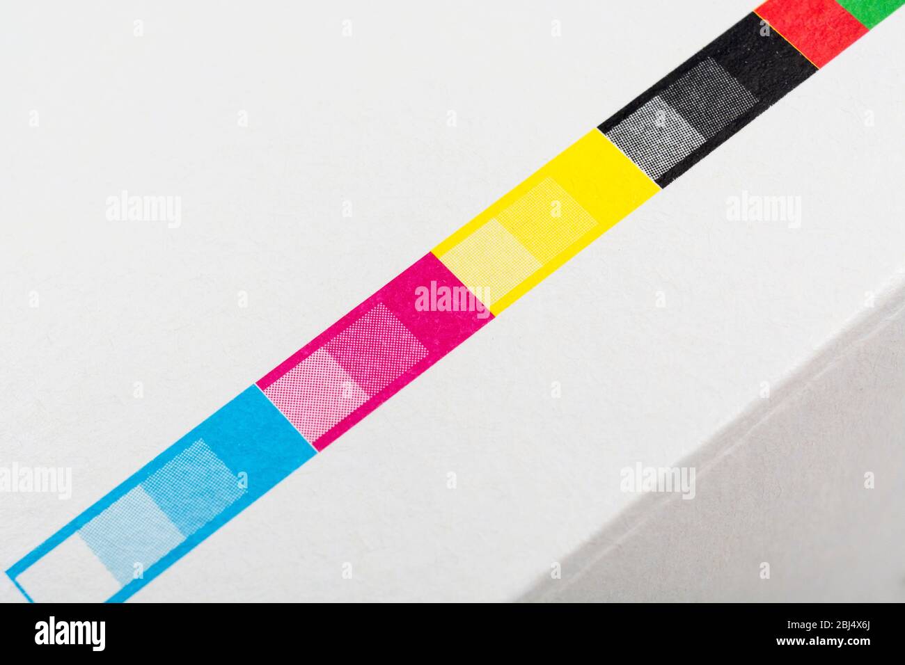 Colour registration strip on paper packaging. For CMYK process colours ...
